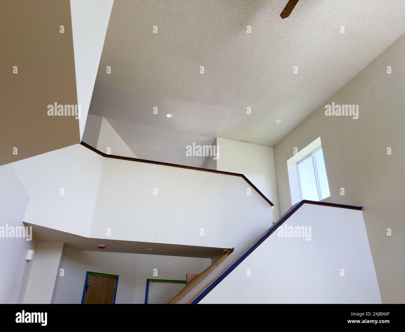 Multi-Level Home Interior Under Renovation with Staircase and Prepped ...