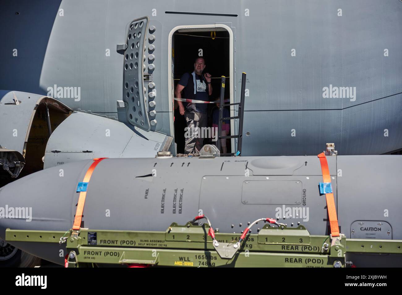 Visitors walk into the cargo bay of a cargo plane to have a look at it ...