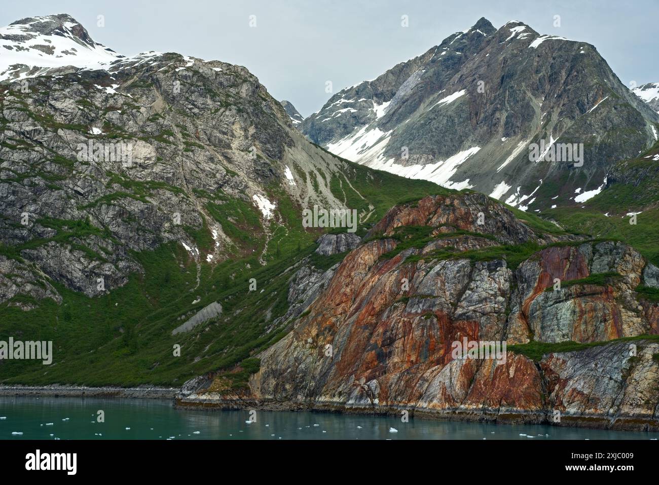 High peaks and rust streaked rock cliffs in Glacier Bay National Park ...