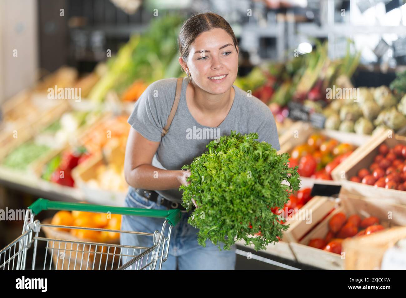 In vegetable department of bio supermarket, female customer took crisp ...