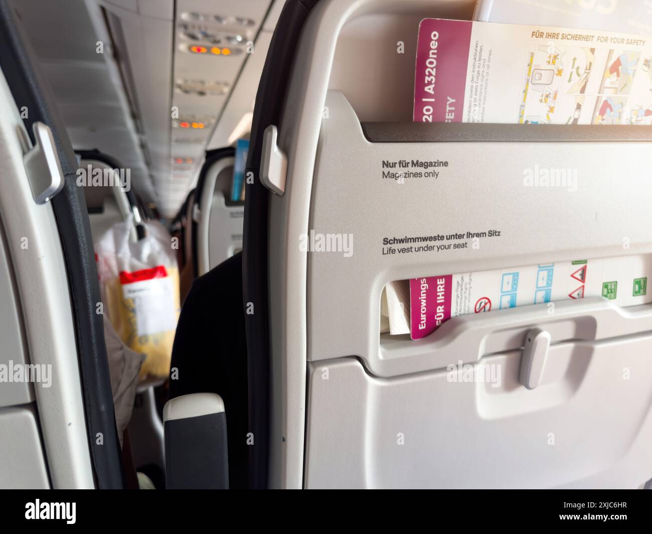 Germany - Jul 11, 2024: View of the back of an aircraft seat on a ...