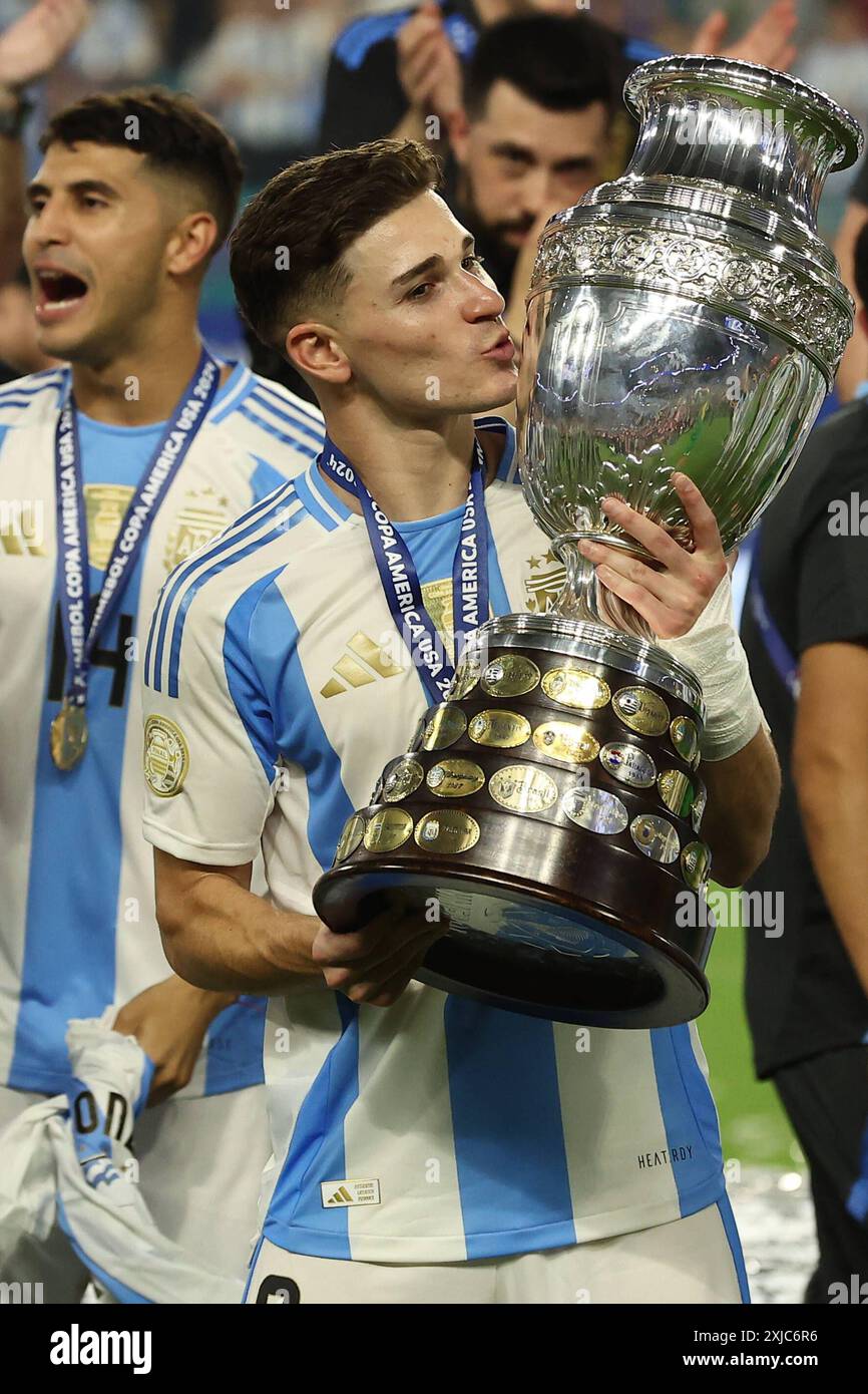 Argentina s forward Julian Alvarez kisses the trophy after defating ...