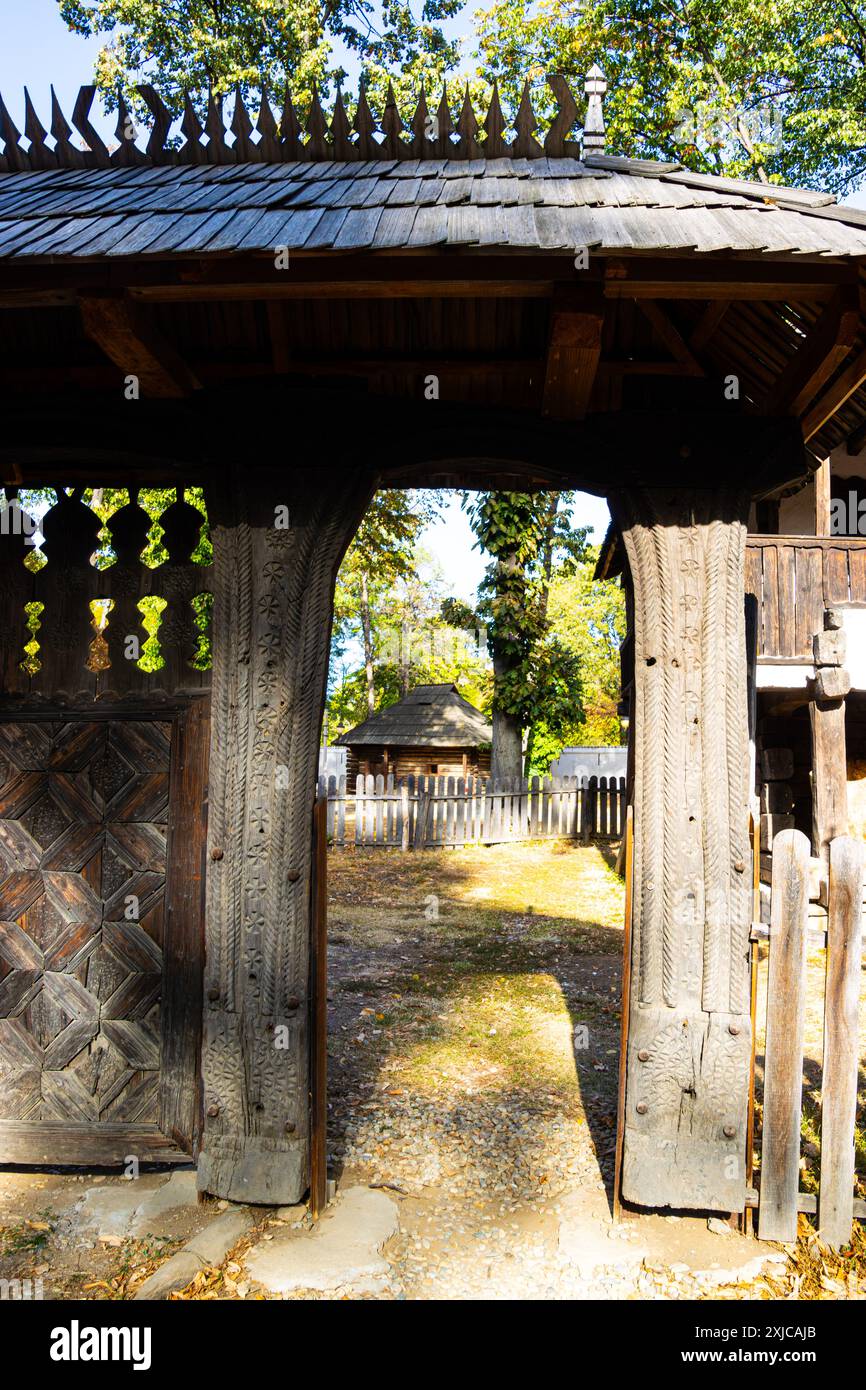 Traditional wooden gate and house at the Dimitrie Gusti Village Museum ...