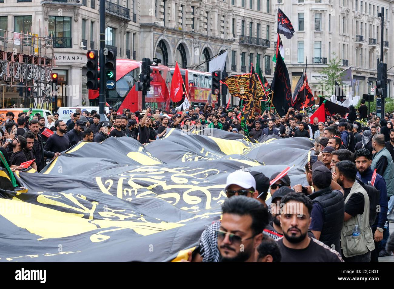 London, UK, 17th July, 2024. A large banner is carried by devotees ...