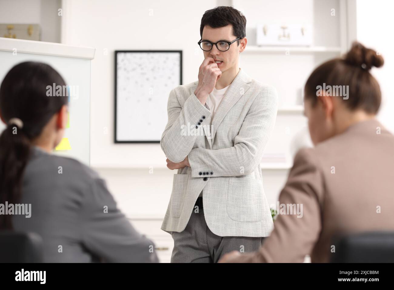 Man feeling embarrassed during business meeting in office Stock Photo ...
