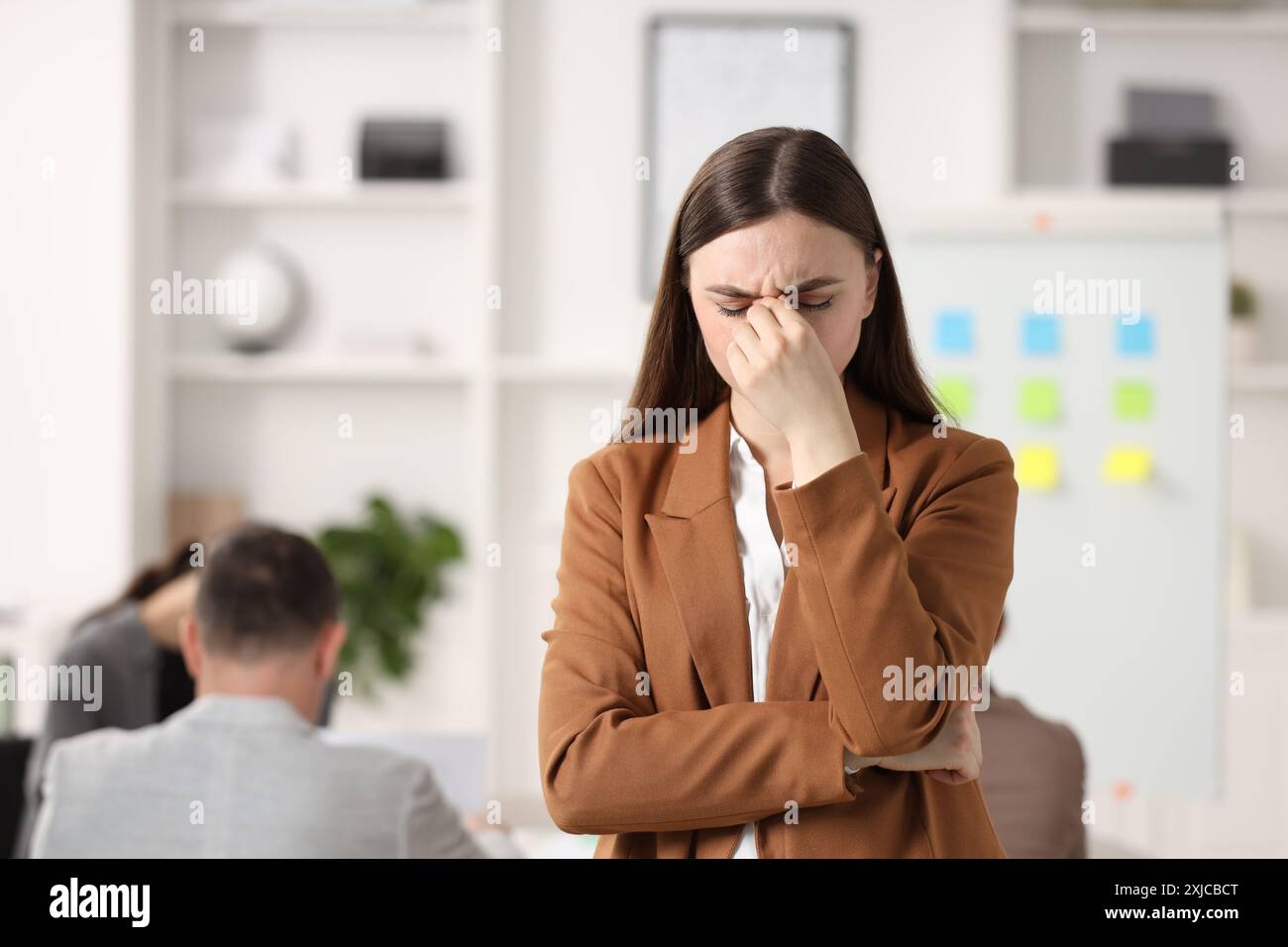 Woman feeling embarrassed during business meeting in office Stock Photo ...