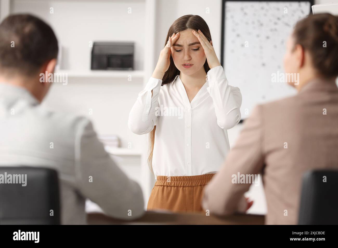 Woman feeling embarrassed during business meeting in office Stock Photo ...