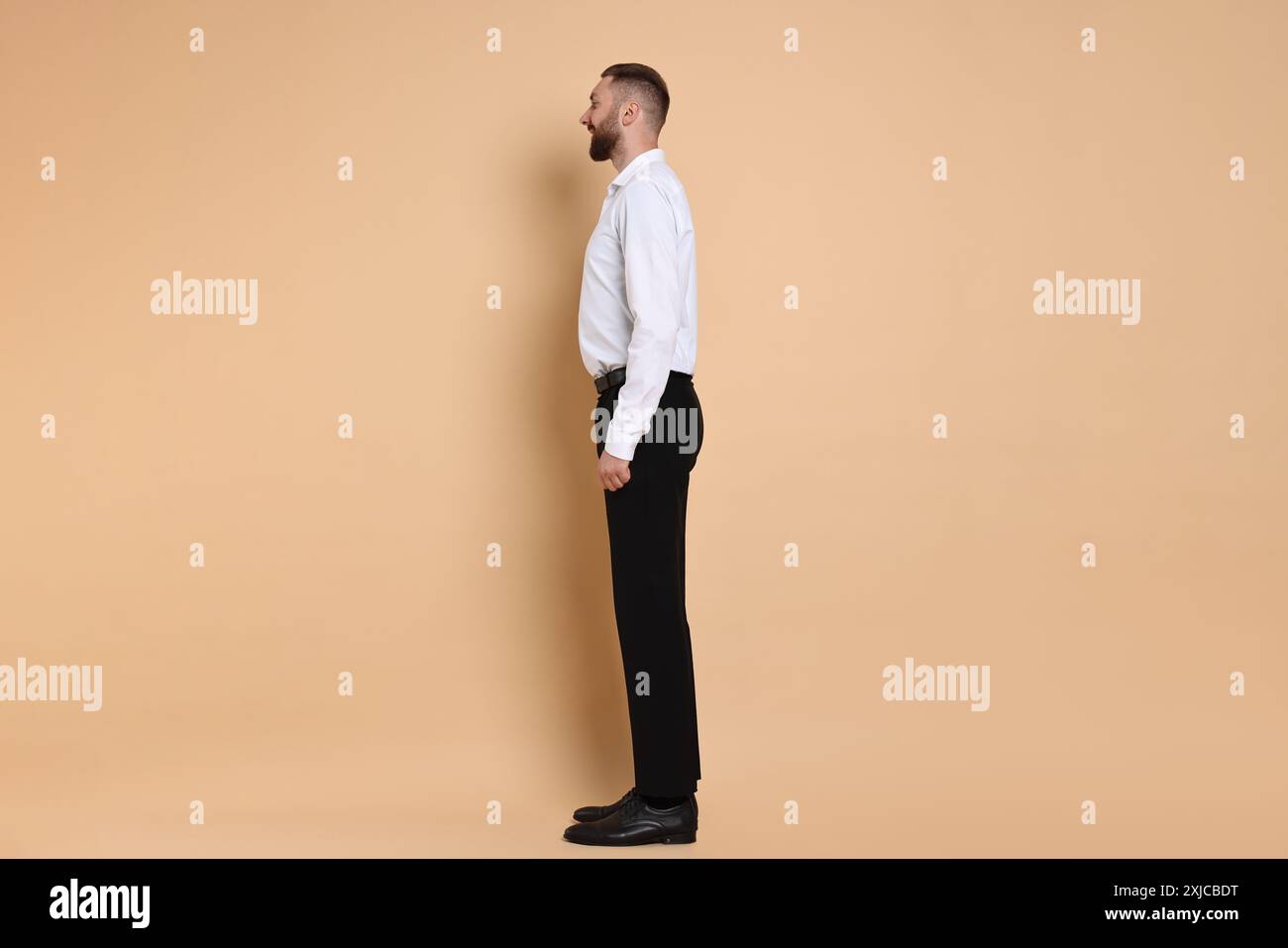 Man with good posture on pale orange background Stock Photo - Alamy