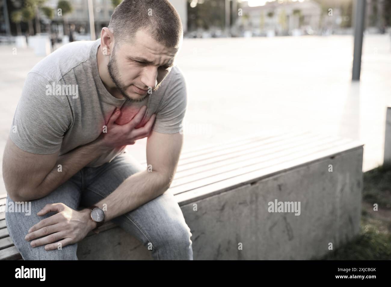 Heart attack. Young man suffering from pain in chest outdoors Stock ...