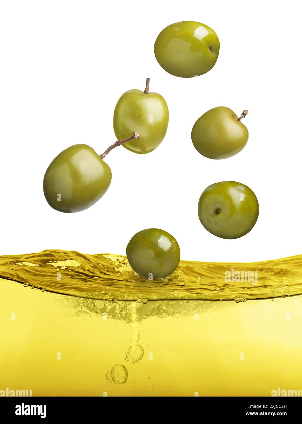 Green olives falling into cooking oil on white background Stock Photo ...