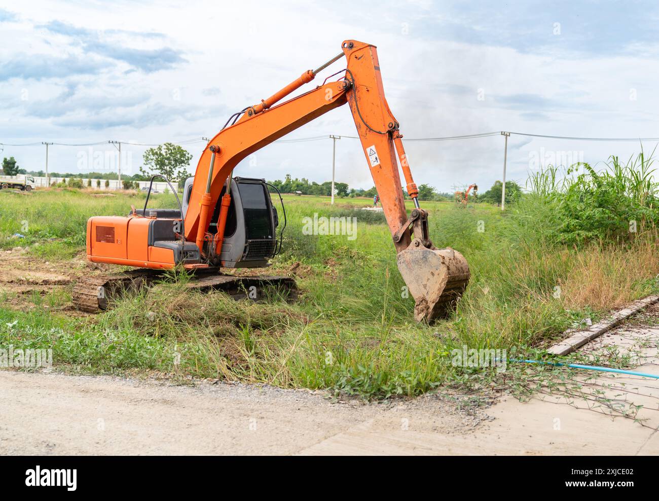 Bucket excavator at work in the countryside in a private yard. Digging ...