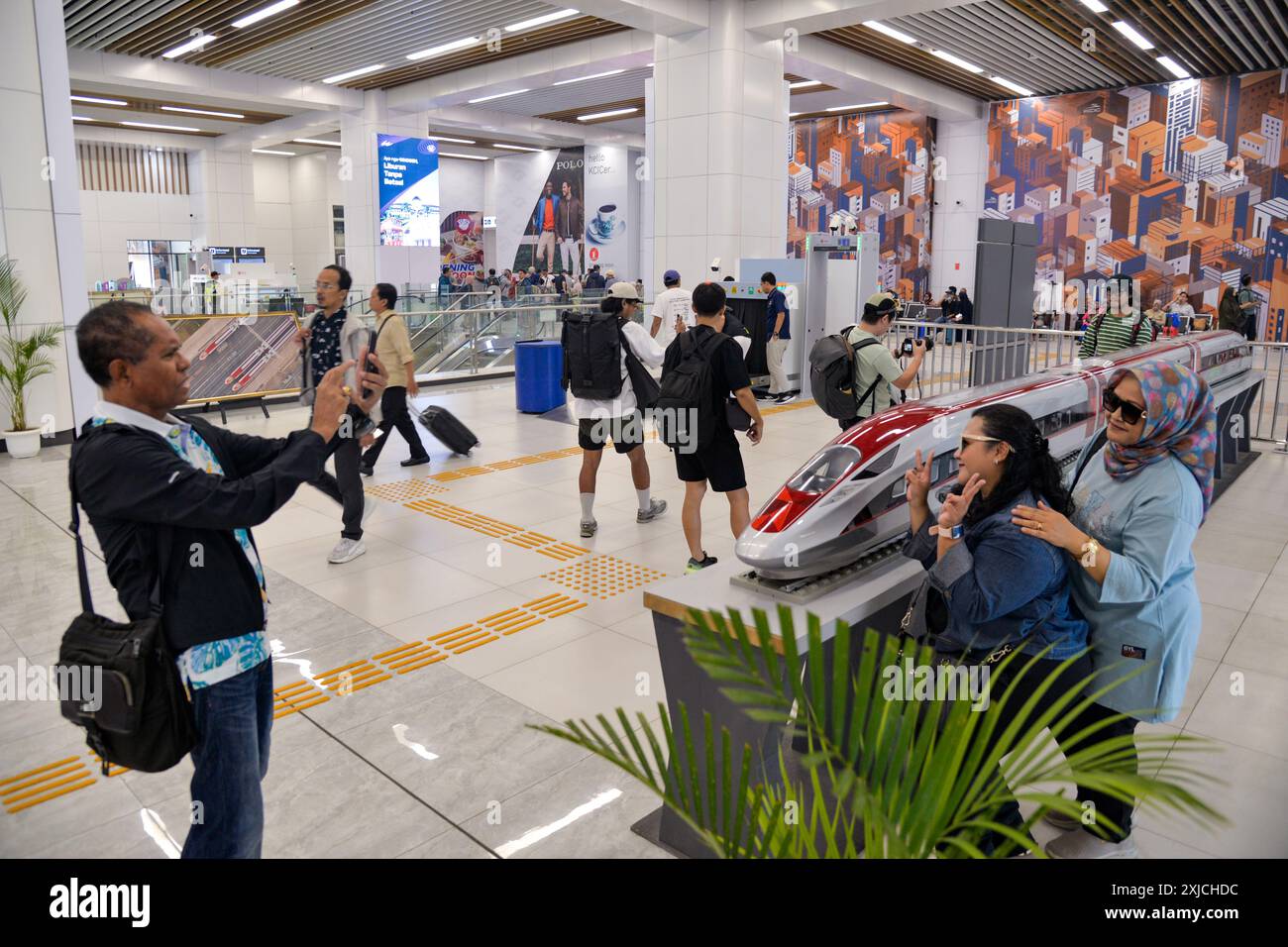 Beijing, Indonesia. 17th July, 2024. Passengers pose for photos with a model of a high-speed ...