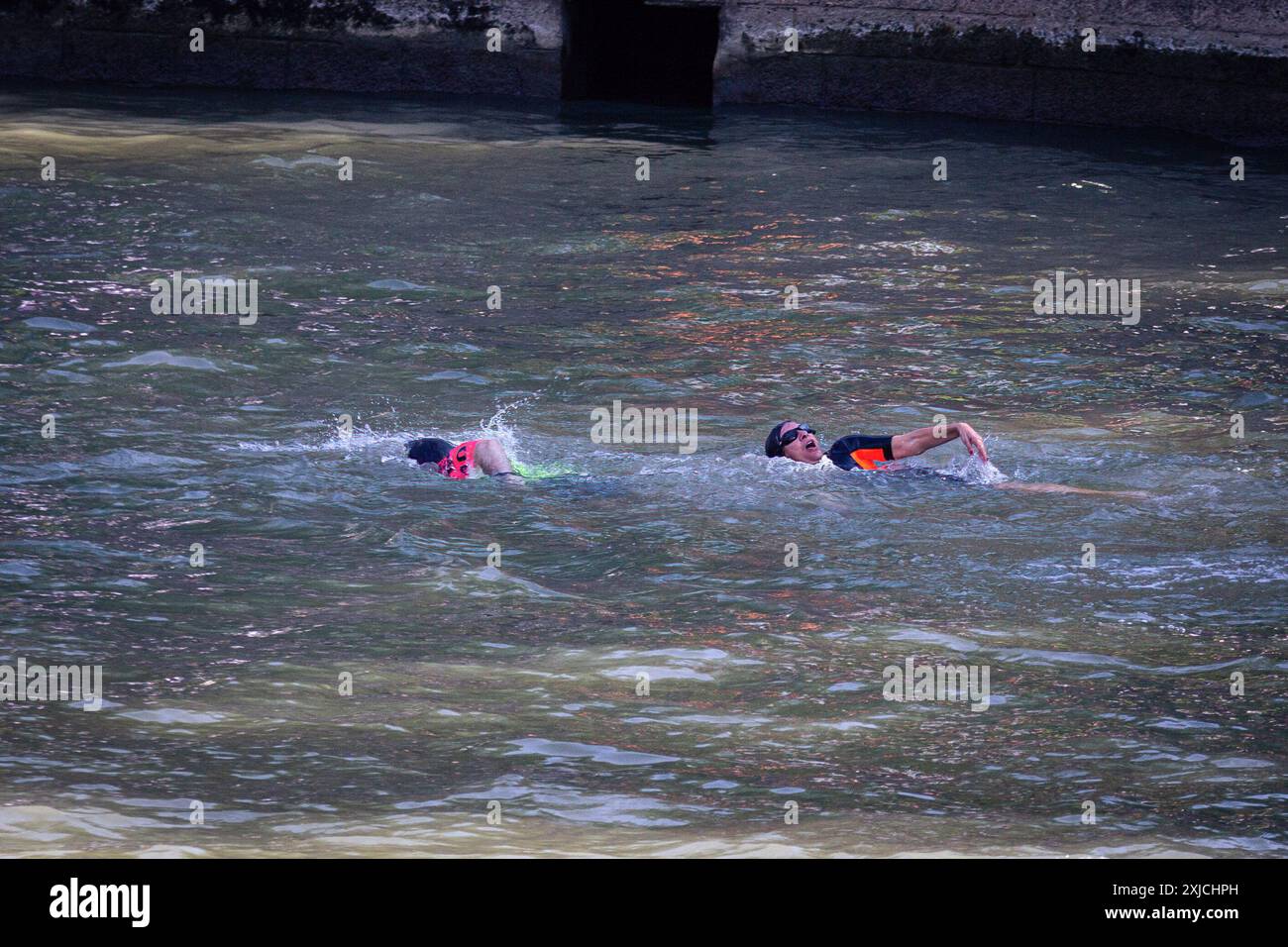 Paris Mayor Anne Hidalgo (R) swims in the Seine water at Bras Marie in ...