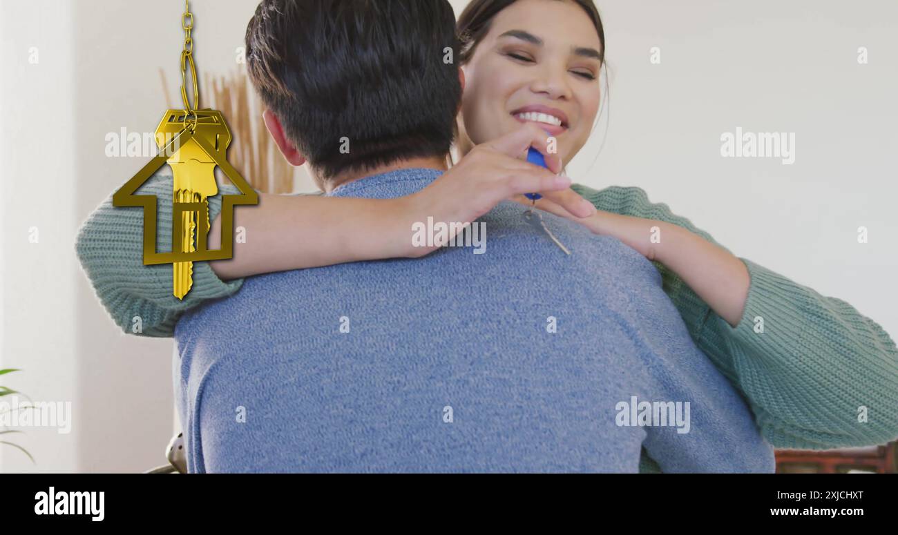 Image of gold house key and key fob over happy diverse couple at new ...