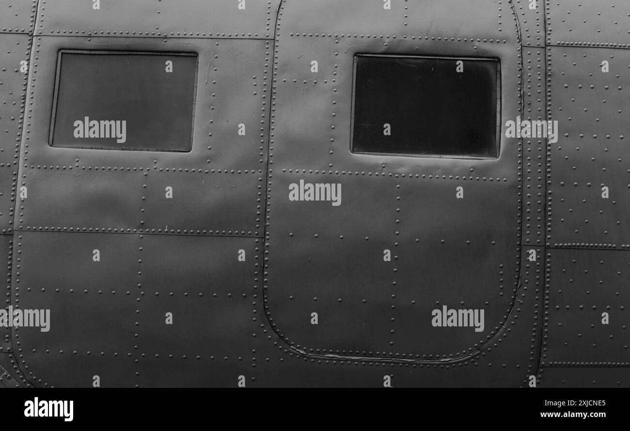 The fuselage of an old military airplane with doors and an illuminator ...