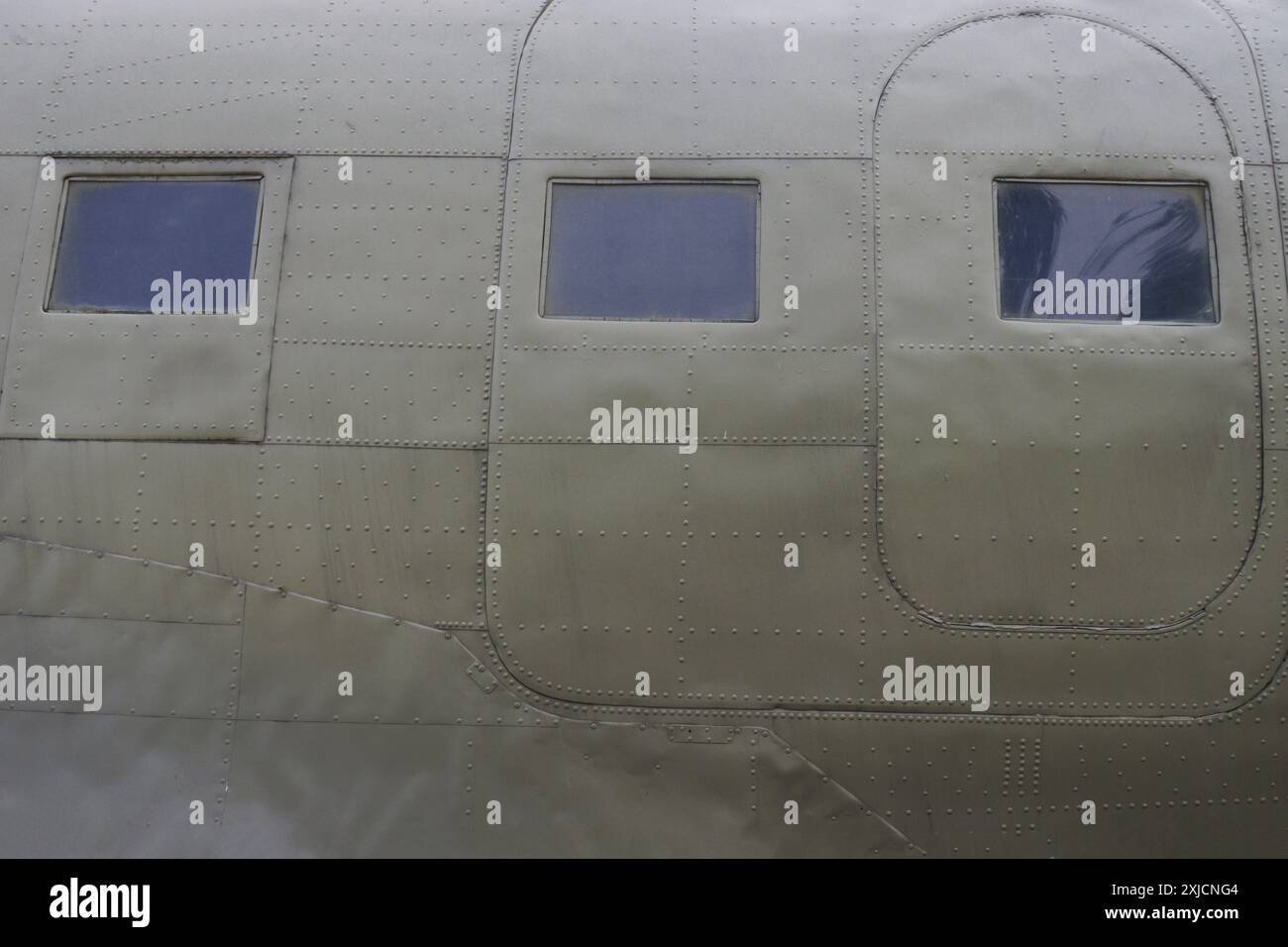 The fuselage of an old military airplane with doors and an illuminator ...