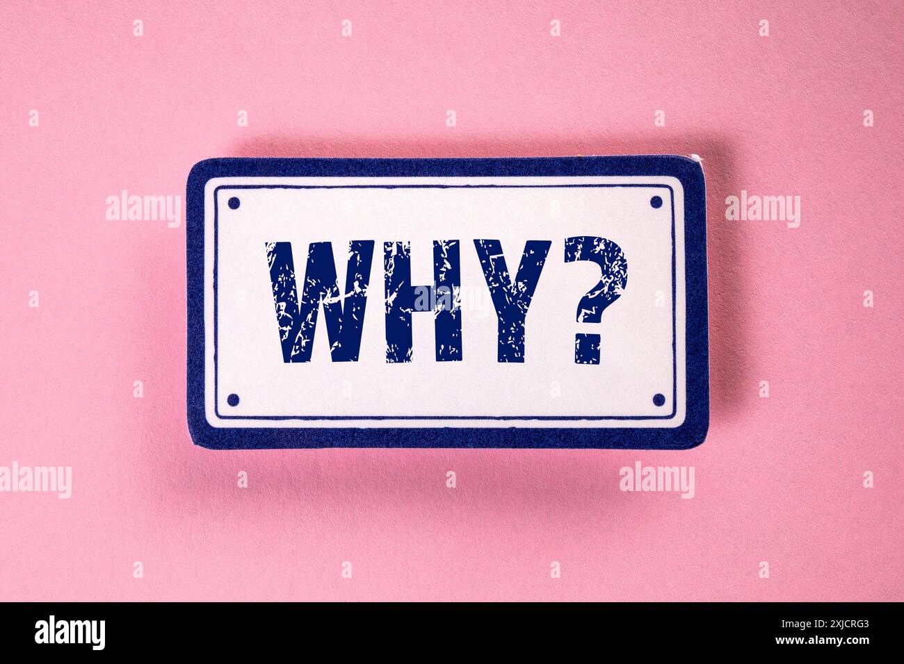 Why. Cardboard sticker with text on a pink background Stock Photo - Alamy