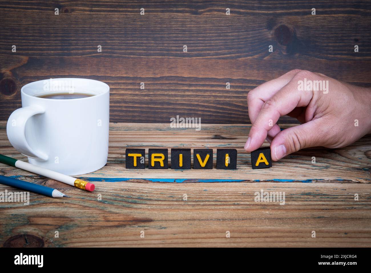TRIVIA. Old letter tiles on a wooden texture office table Stock Photo ...