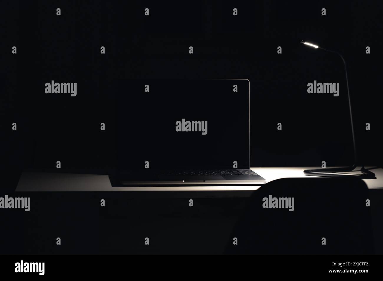 Black laptop screen in a dark room at night Stock Photo - Alamy