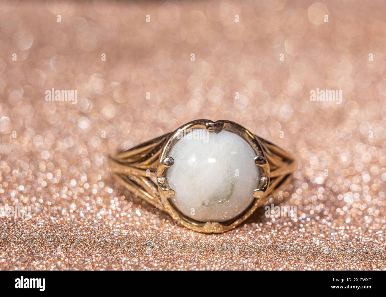 Close up of fashion golden ring decorated with white goshenite. Gold ...