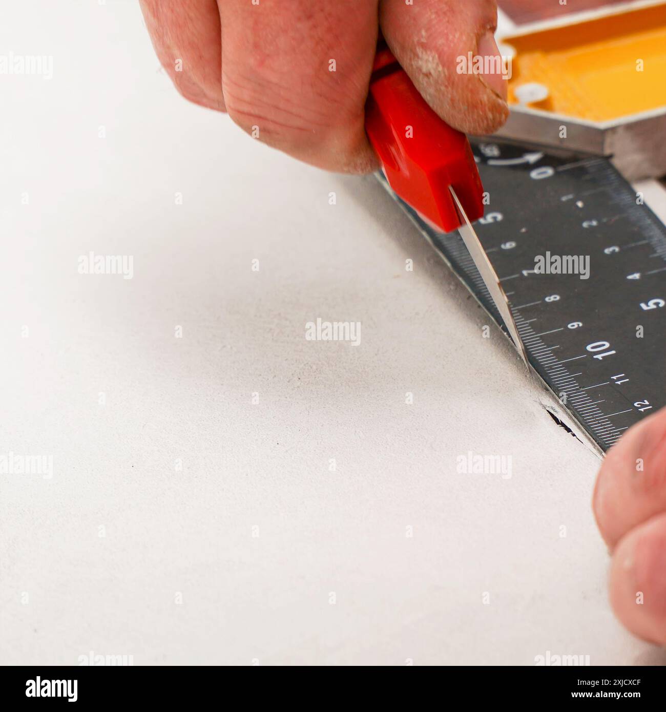 A man cuts a plastic pvc panel with a construction knife Stock Photo ...
