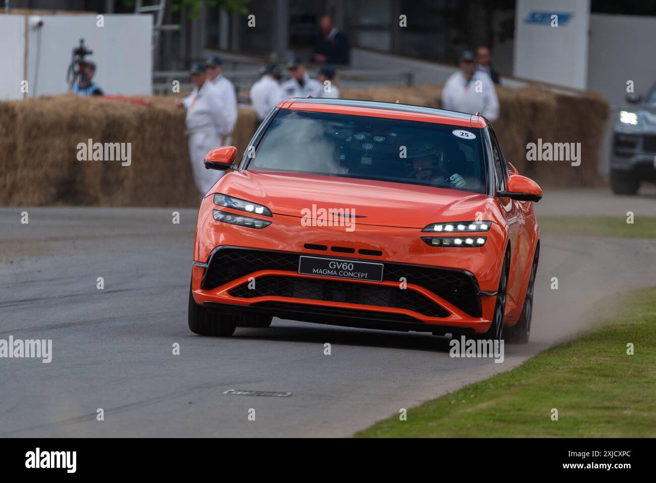 2024 Genesis GV60 Magma Concept car driving up the hill climb track at ...