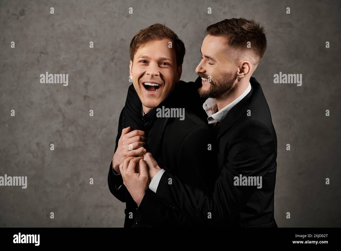 Two men in suits laughing together Stock Photo - Alamy
