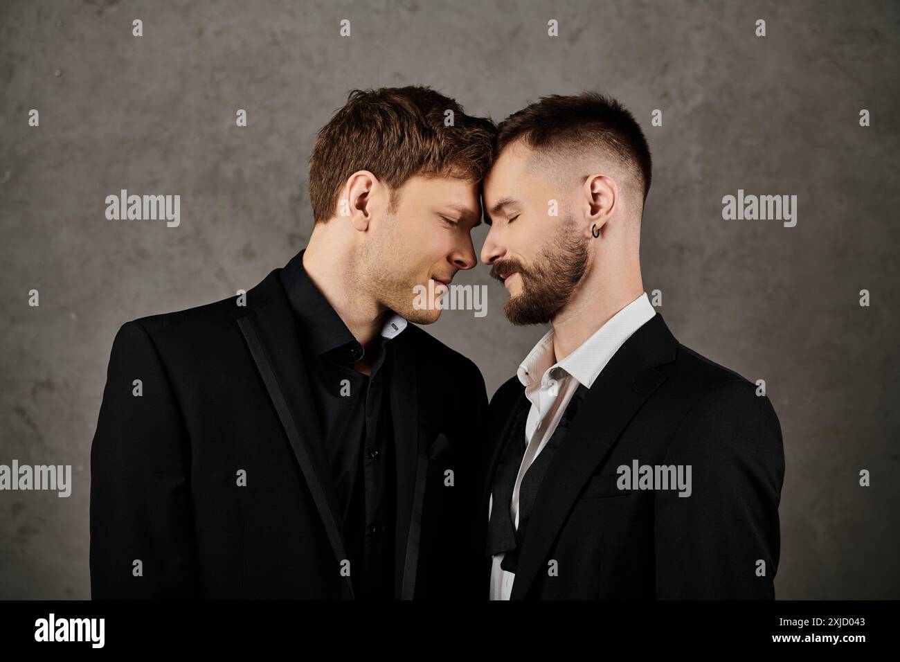 Two men in suits share a tender moment together Stock Photo - Alamy