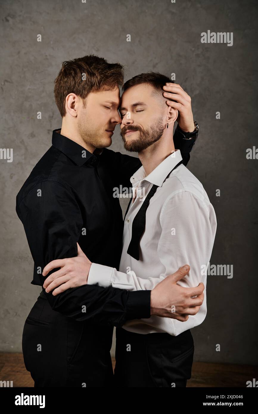Two men in sharp suits embrace tenderly Stock Photo - Alamy