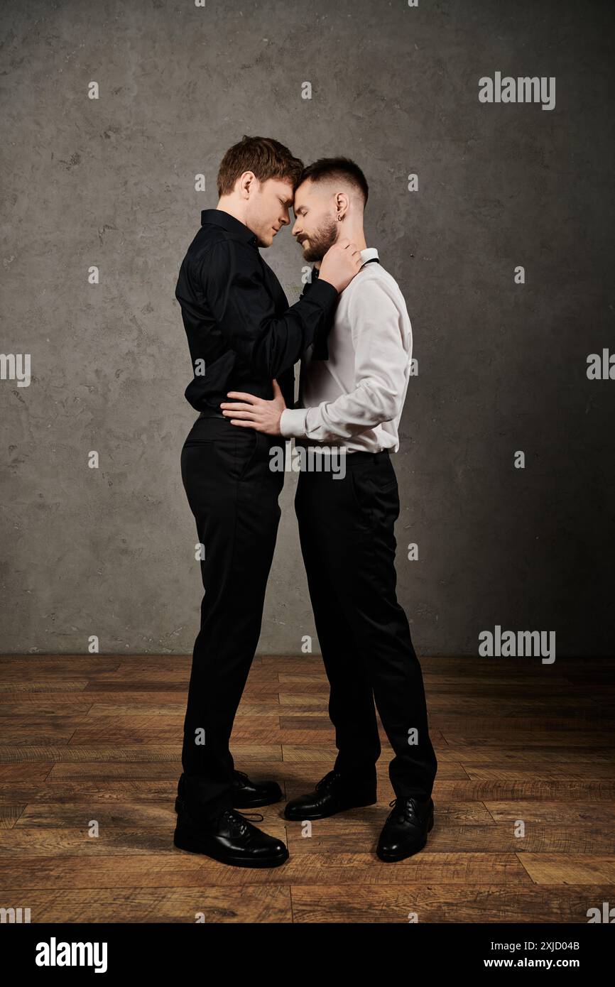 Loving gay couple in dapper suits, touching foreheads, show affection ...