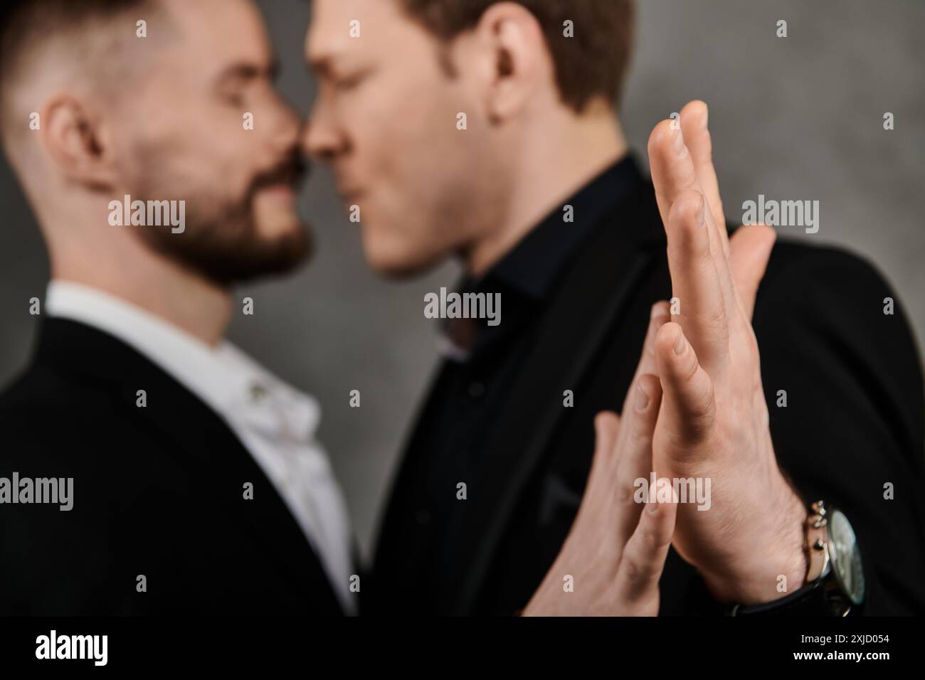 Two men in suits stand close, their faces close together Stock Photo ...