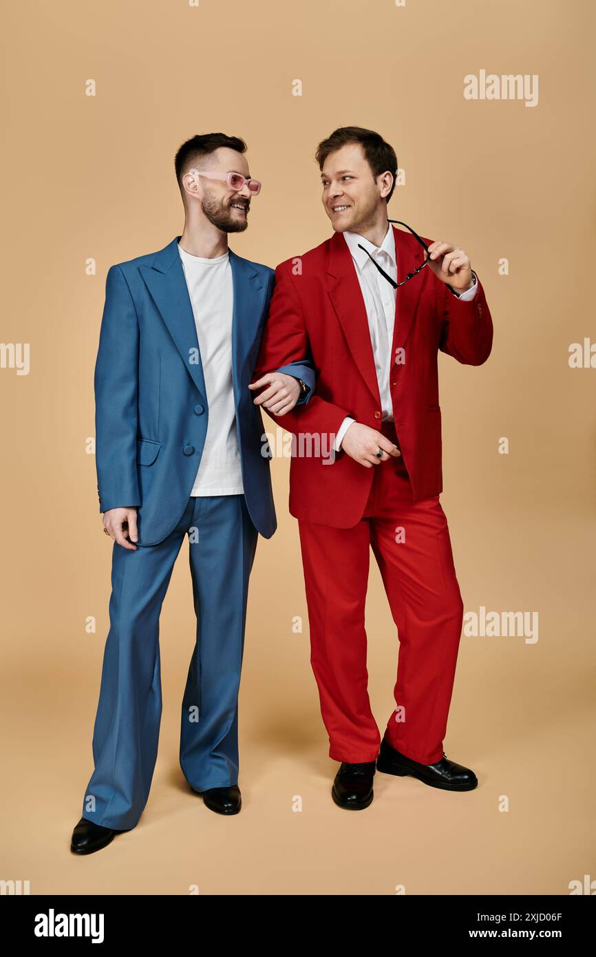 Two men in suits stand smiling and looking at each other Stock Photo ...