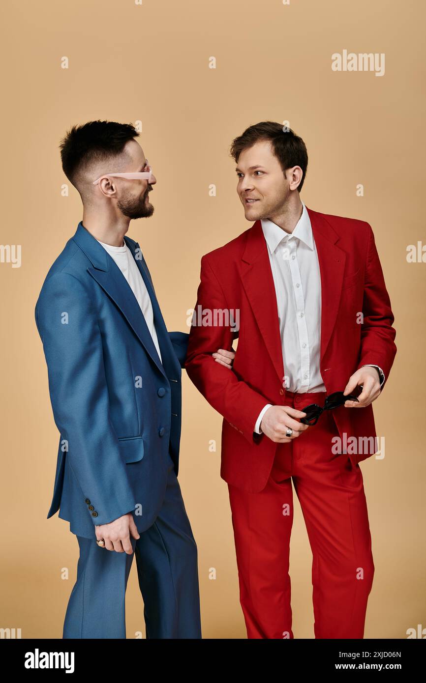 Two men in elegant suits stand close, sharing a laugh and a tender ...
