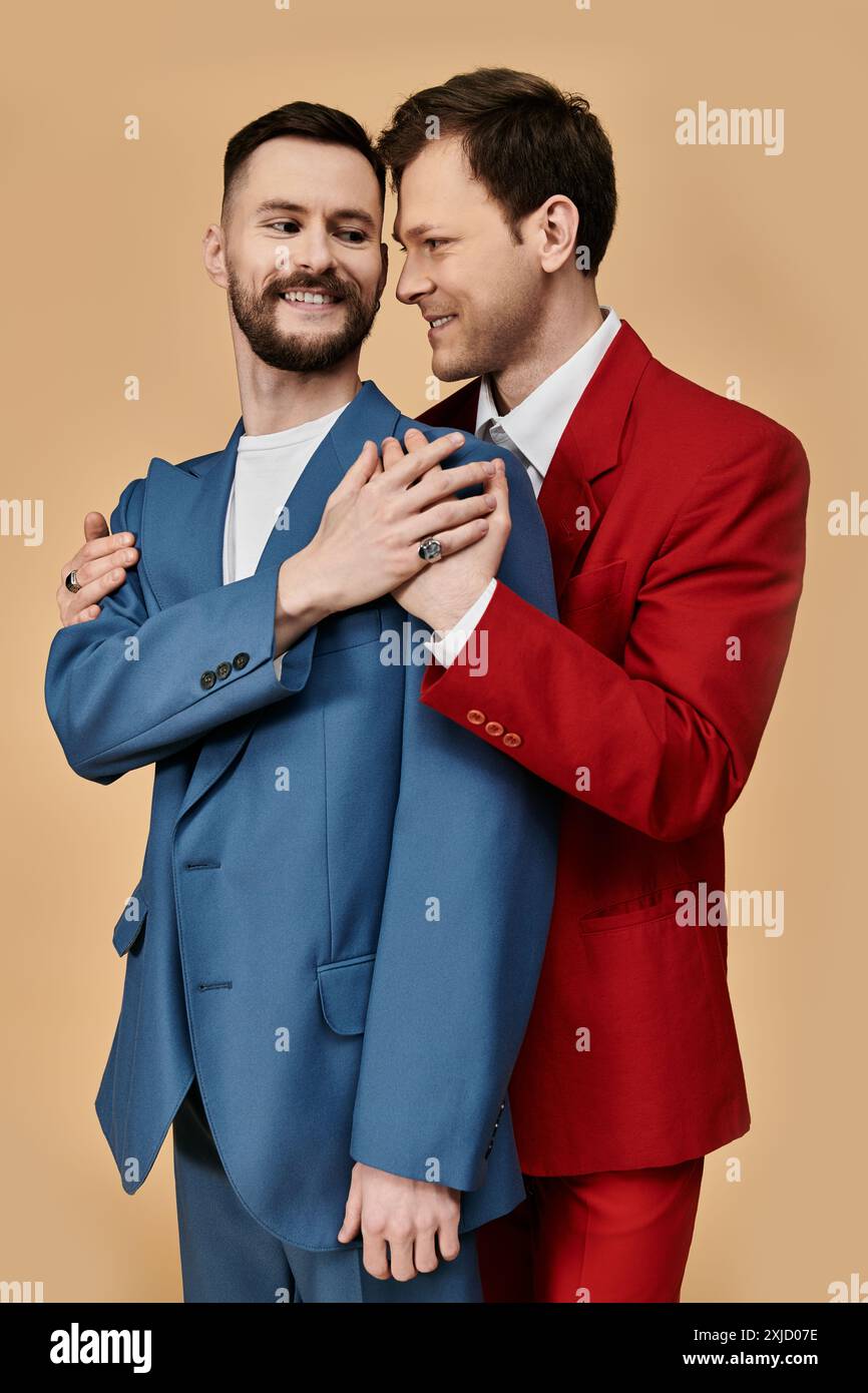Two men in elegant suits embrace lovingly, showcasing their affection ...