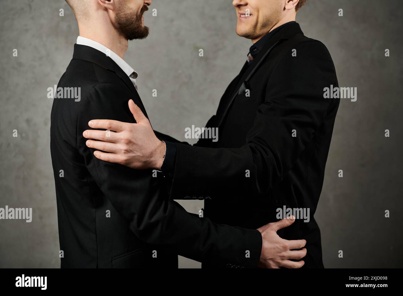 Two men in stylish suits embrace, expressing their love and connection ...