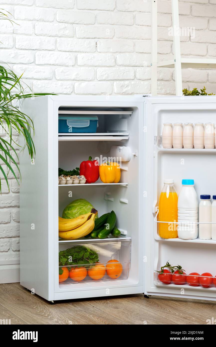 Open White Refrigerator With Fresh Produce In A Kitchen Stock Photo - Alamy