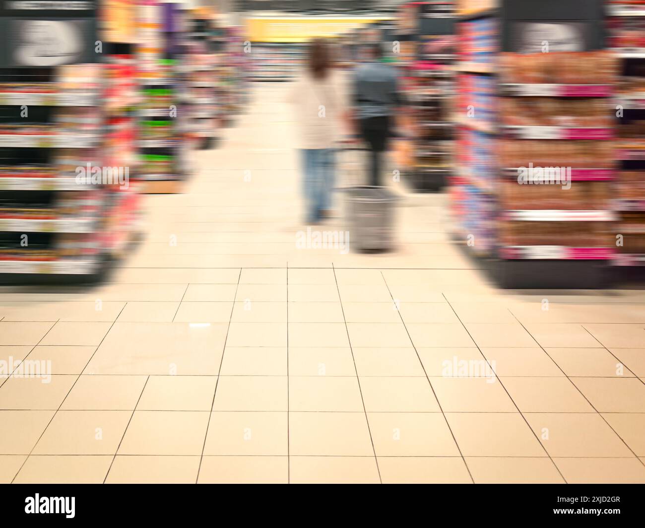 Supermarket aisle with shoppers. Abstract blur as background. Copy ...