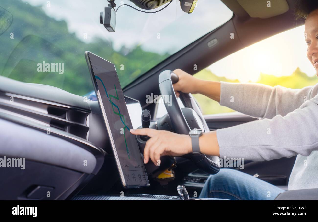 happy man smiling friendly, driving a modern car, interacting with a ...