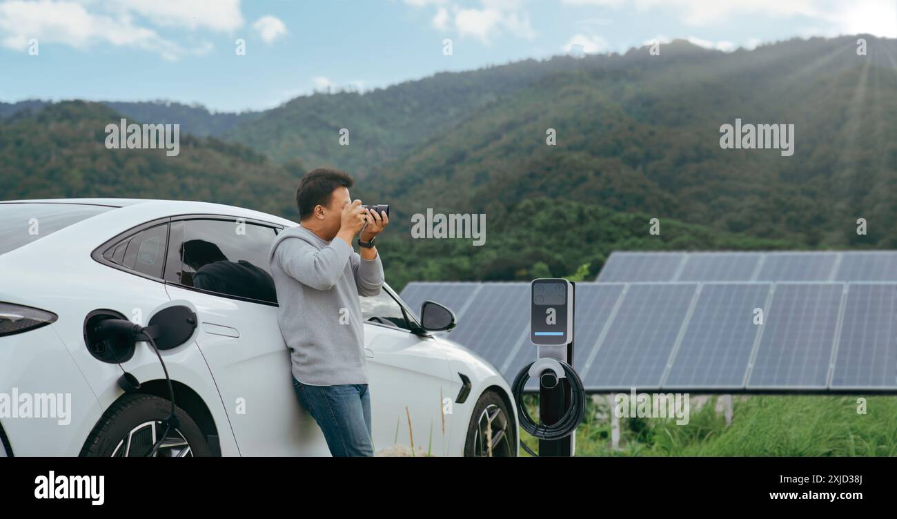 EV car with electric vihicle charging station. Solar farm. Renewable ...