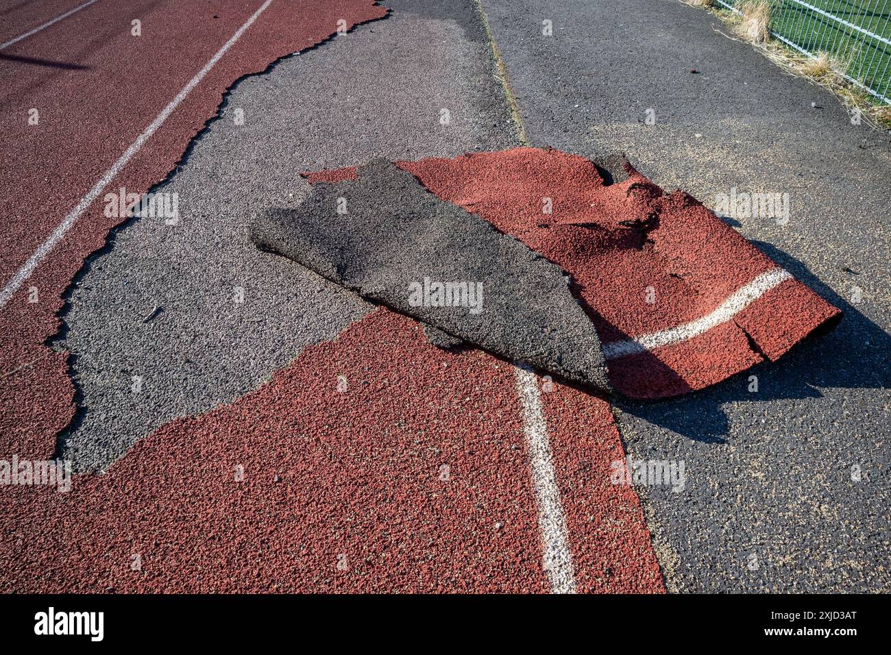damage on the surface of rubber sport track outdoors Stock Photo - Alamy