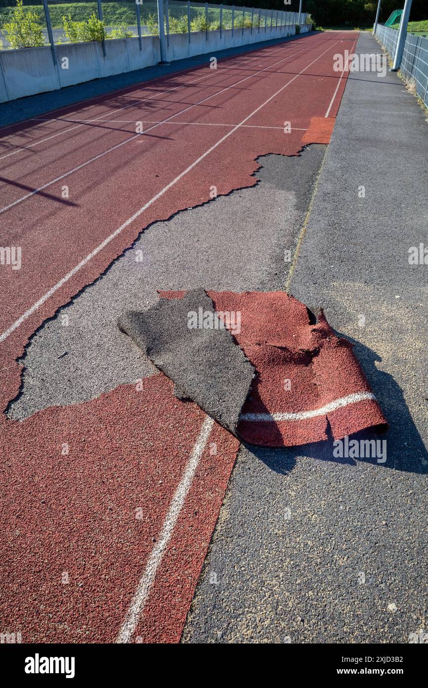 damage on the surface of rubber sport track outdoors Stock Photo - Alamy