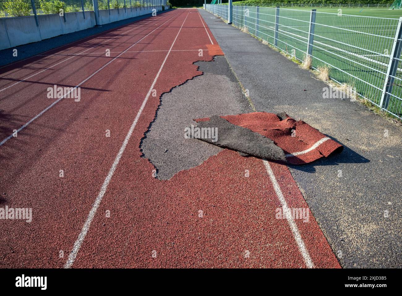 damage on the surface of rubber sport track outdoors Stock Photo - Alamy