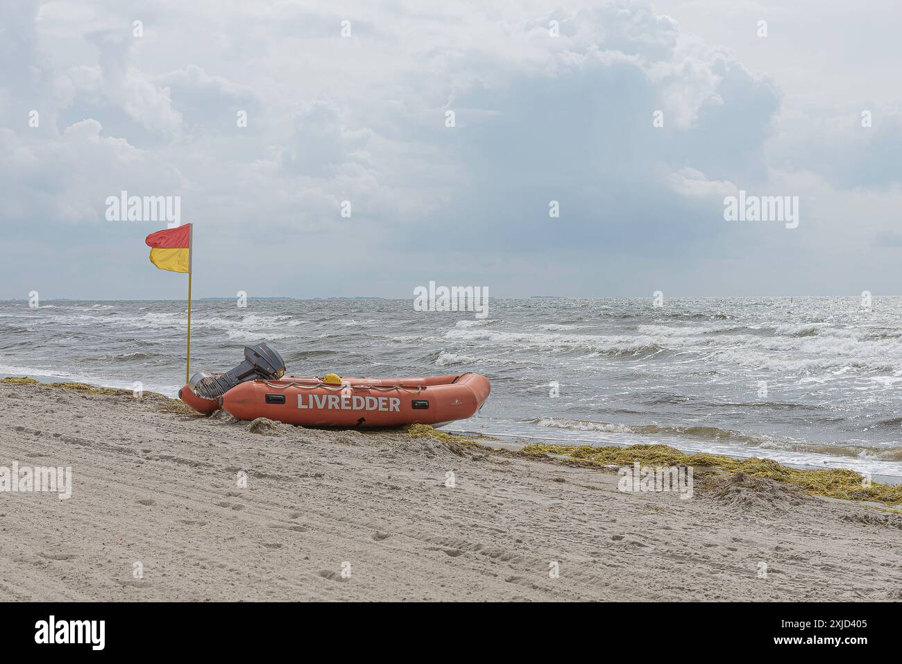 lifeguard boat and a red and yellow flag at a beach, Denmark, August 9 ...