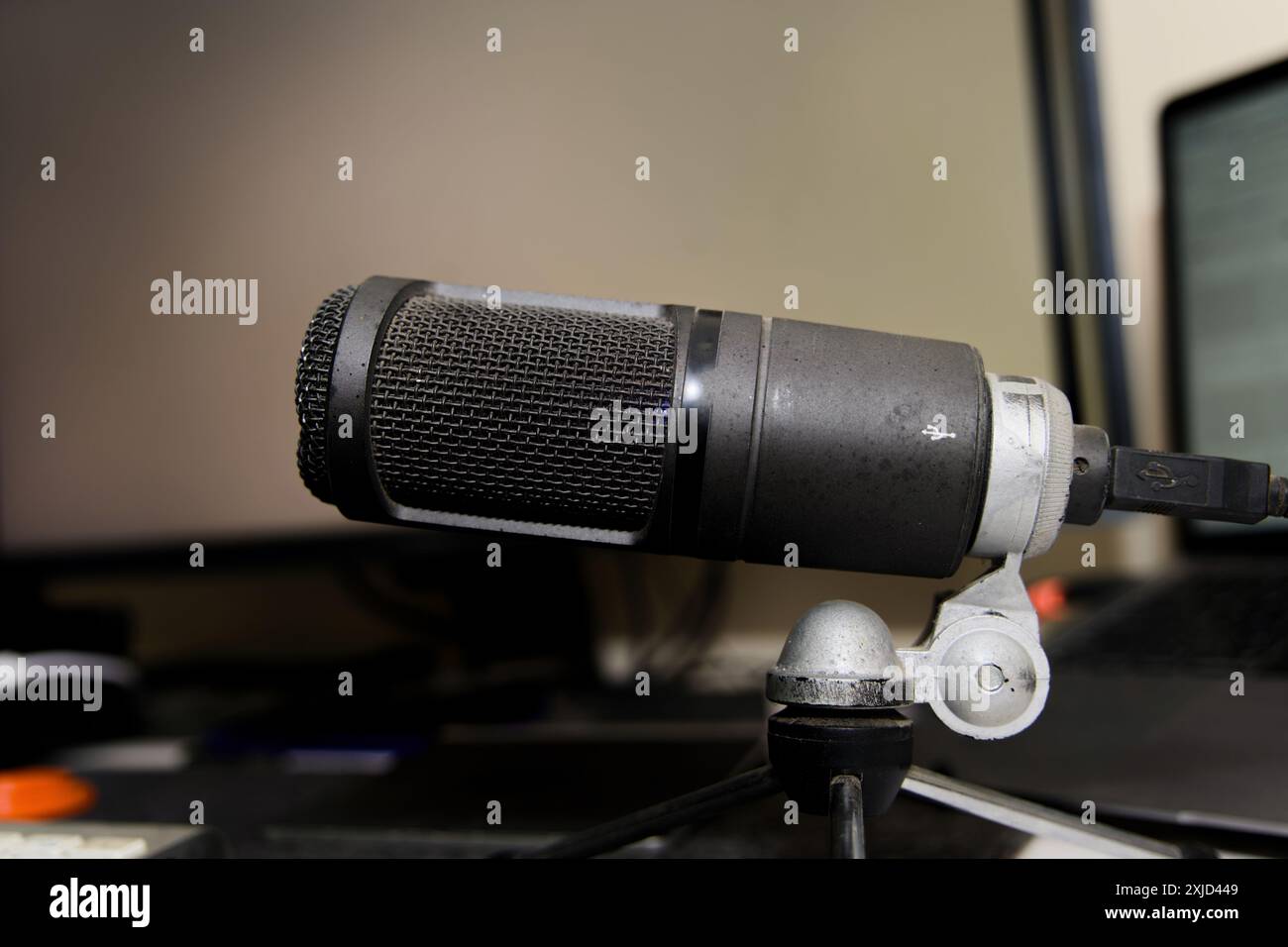 A close-up of a USB microphone in a home studio setting, ready to ...