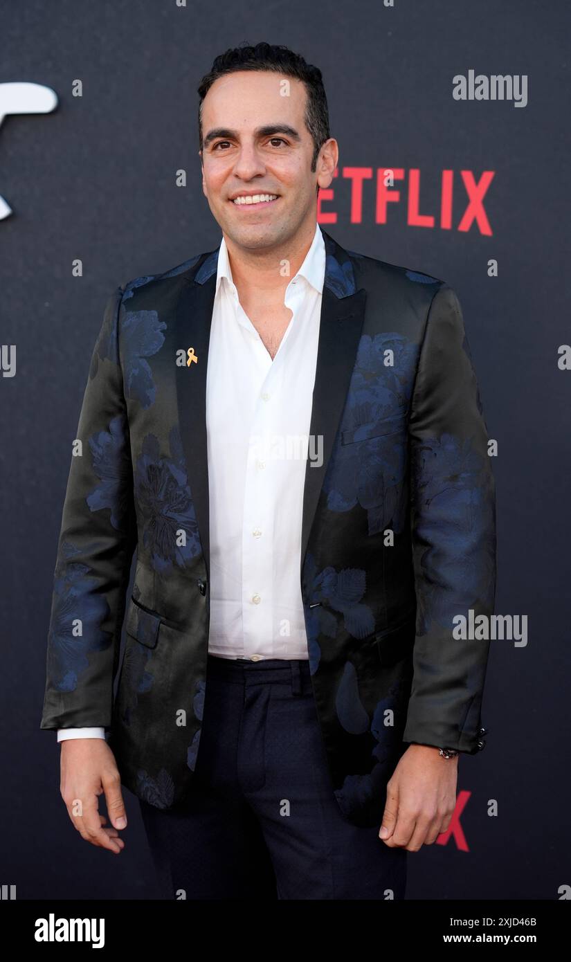 Dan Ahdoot poses at the season six premiere of the Netflix series ...