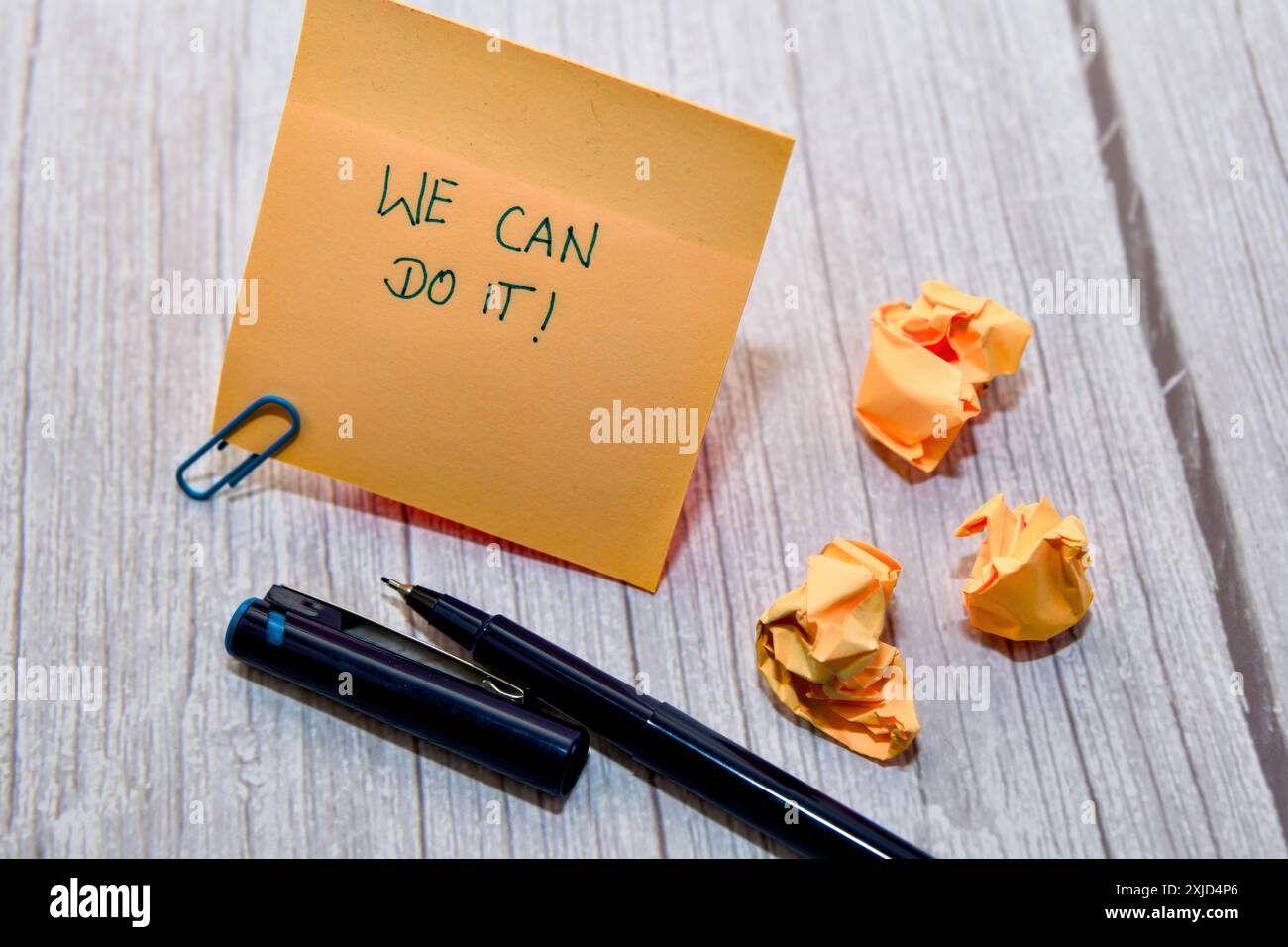 Orange sticky note with motivating message, perfect for success and ...