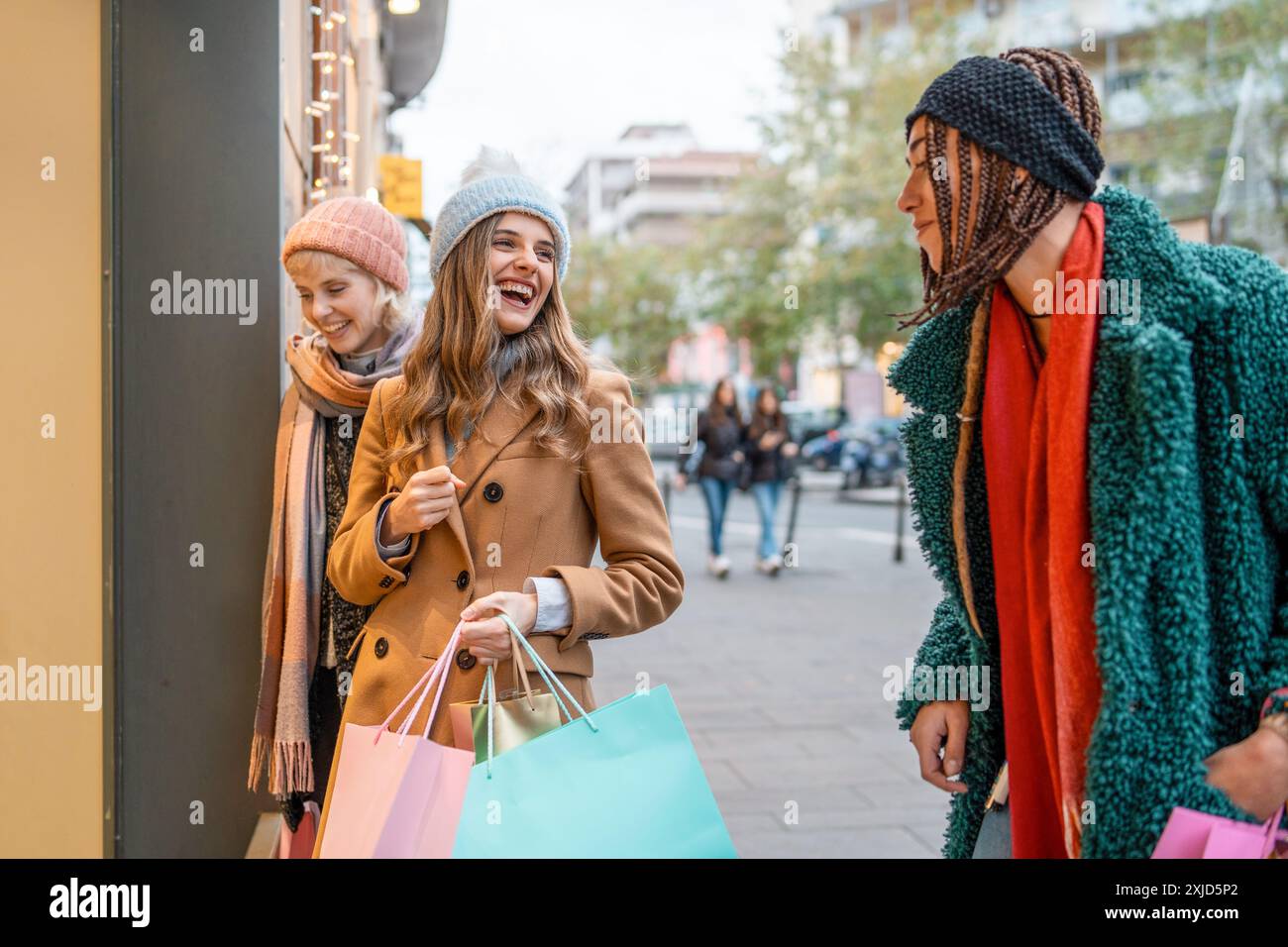 Joyful group of diverse women shopping in urban setting. Friends ...