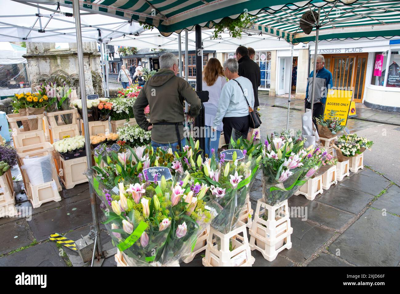 Wells city centre market day, florist flowers stall in market square ...