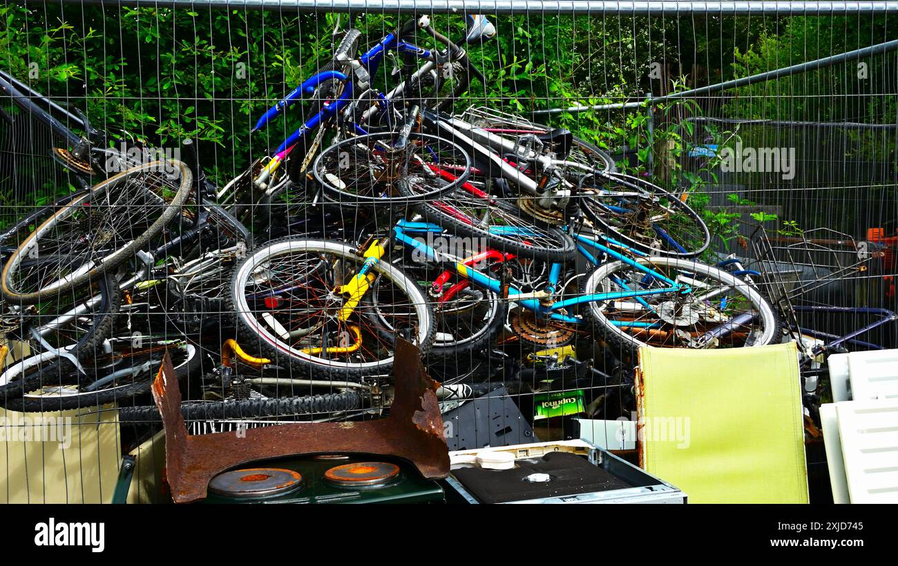 piles of cycles/bikes ready for recycling, including tyres, wheels and ...