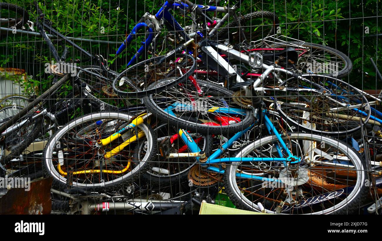 piles of cycles/bikes ready for recycling, including tyres, wheels and ...